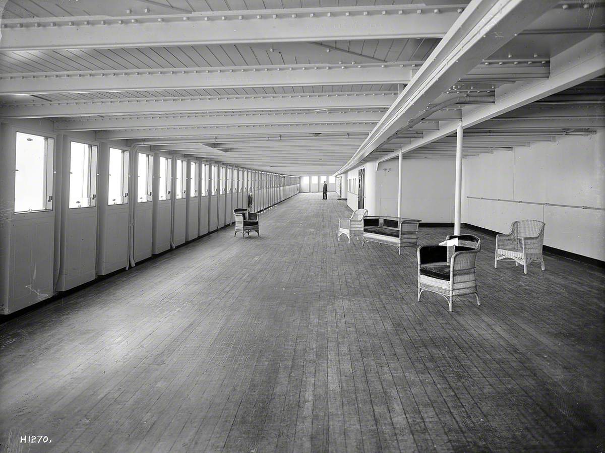 View forward along portside enclosed upper promenade deck, including ...